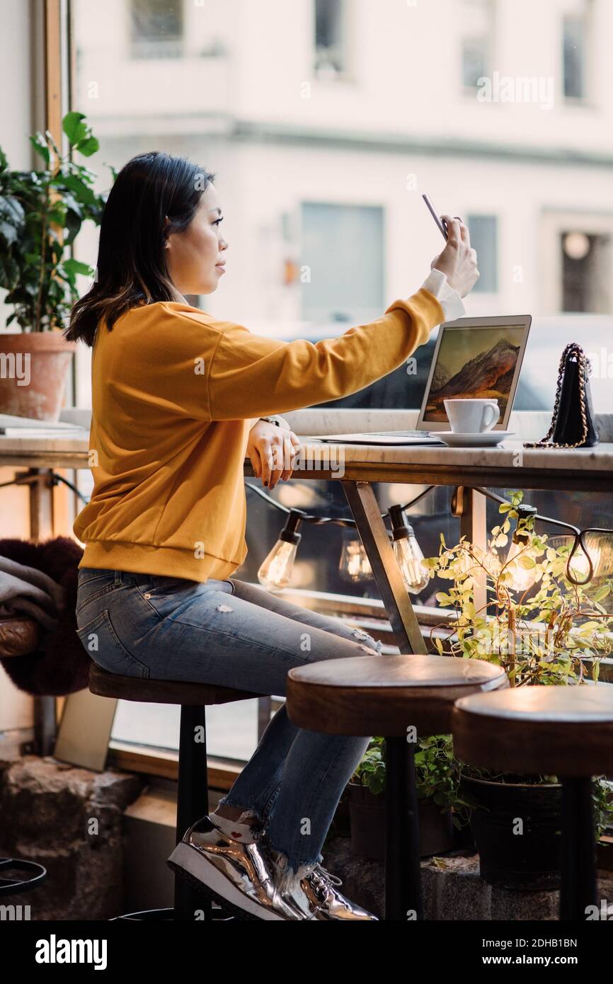 Female blogger sitting cafe taking hi-res stock photography and images ...