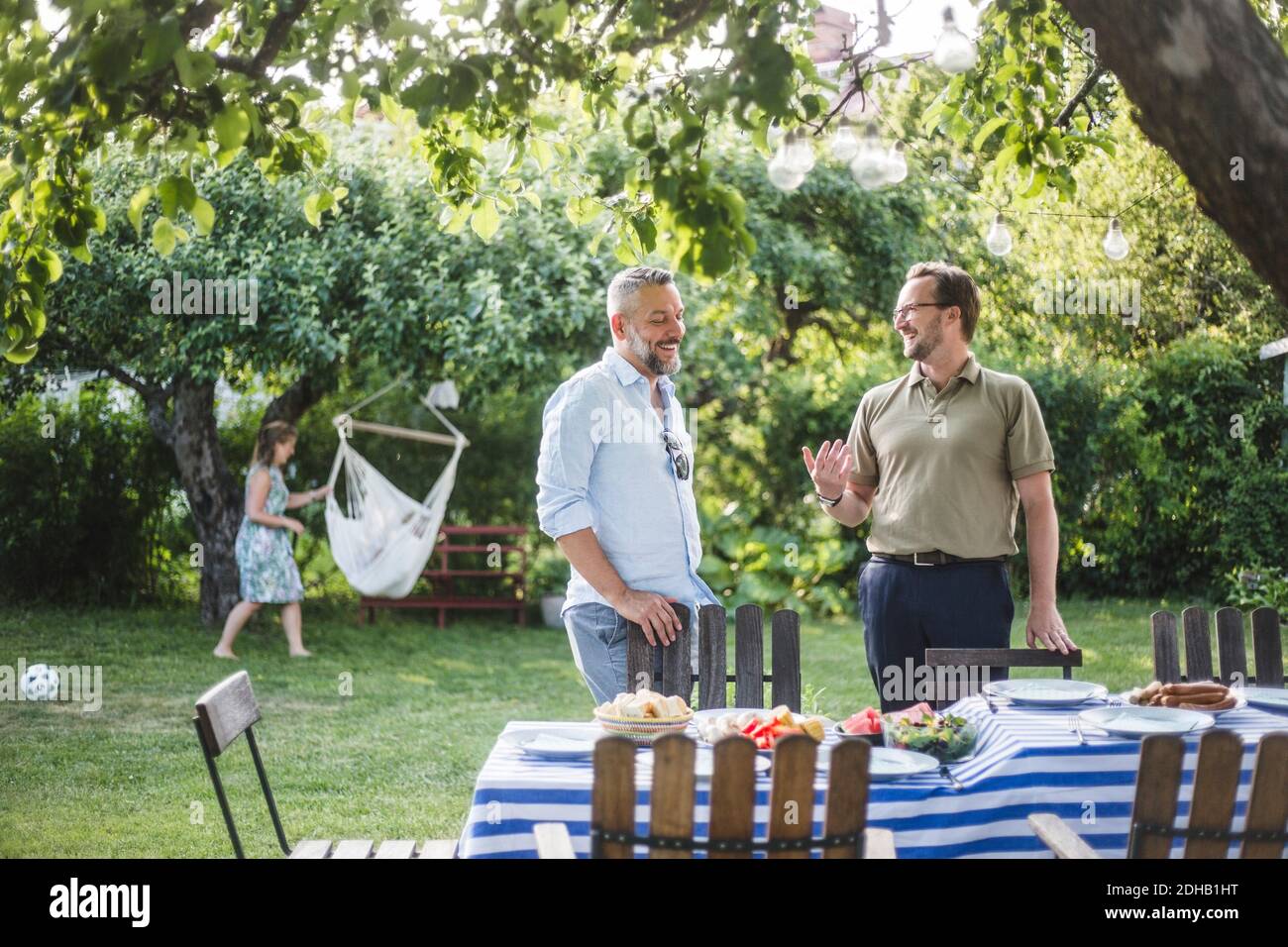 Happy male friends spending weekend together during party in backyard ...