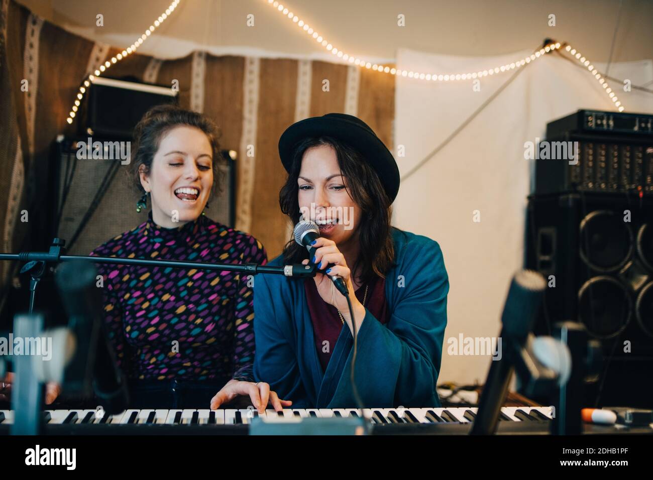 Performers playing piano and singing while practicing in studio Stock ...
