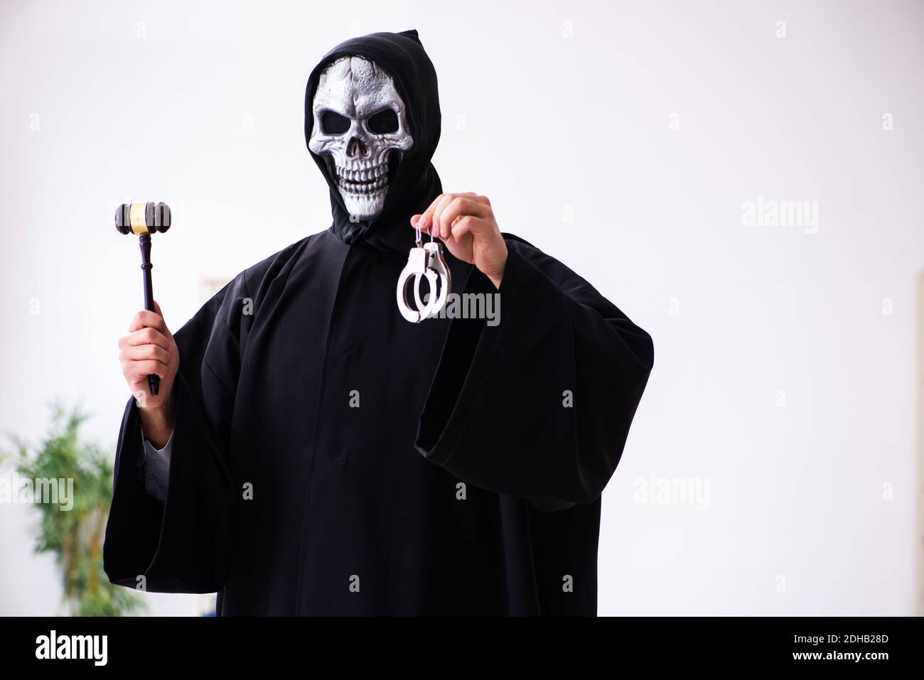 Demon judge working in the courthouse Stock Photo - Alamy