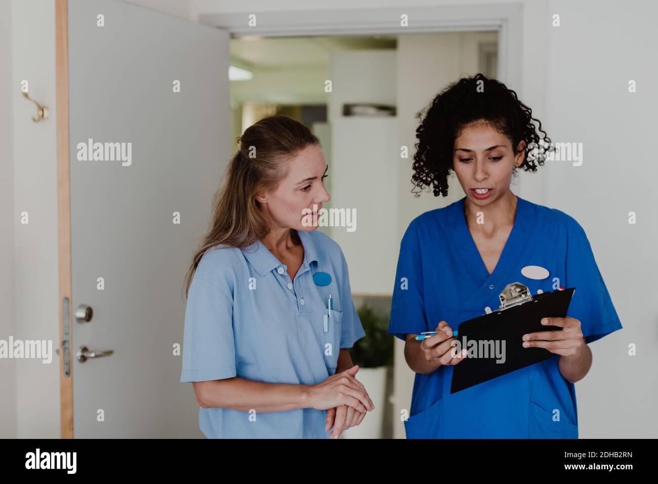 Female nurse showing medical reports to doctor in hospital Stock Photo ...