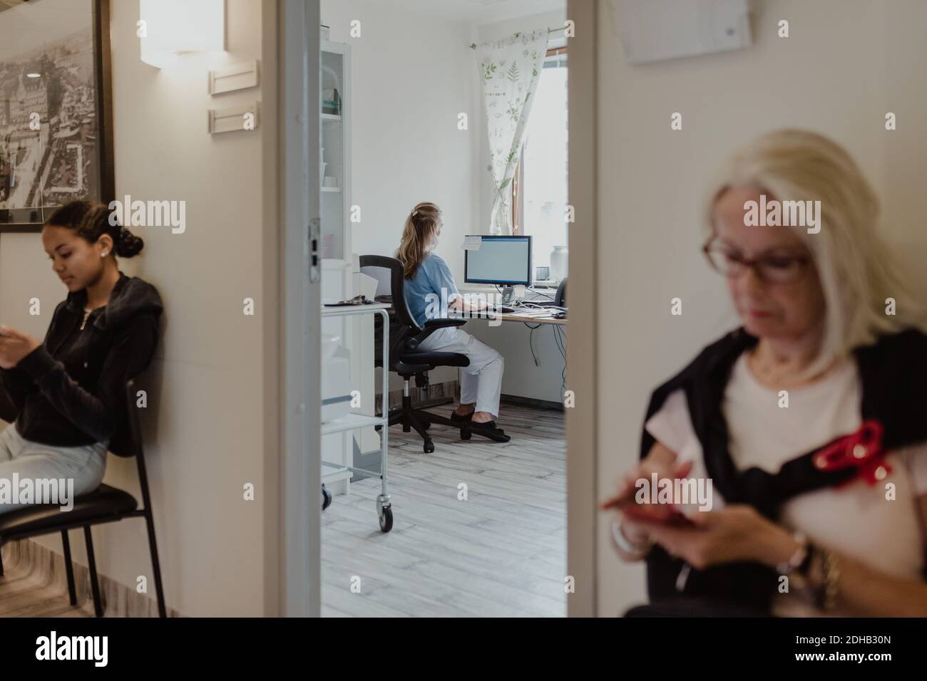 Females using mobile phones while waiting outside medical examination ...