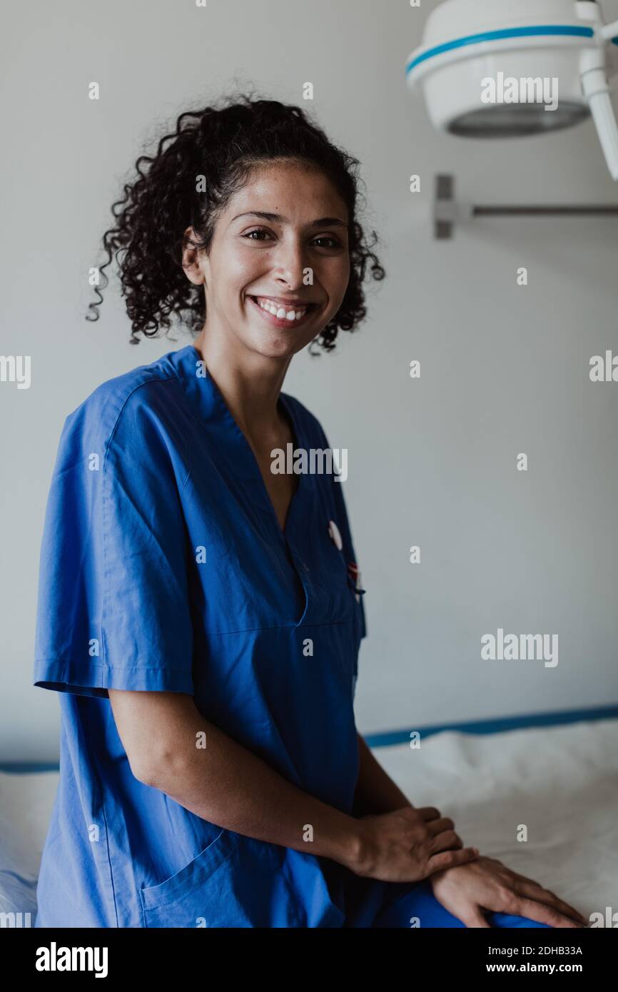 Portrait of confident female doctor sitting in medical clinic Stock ...