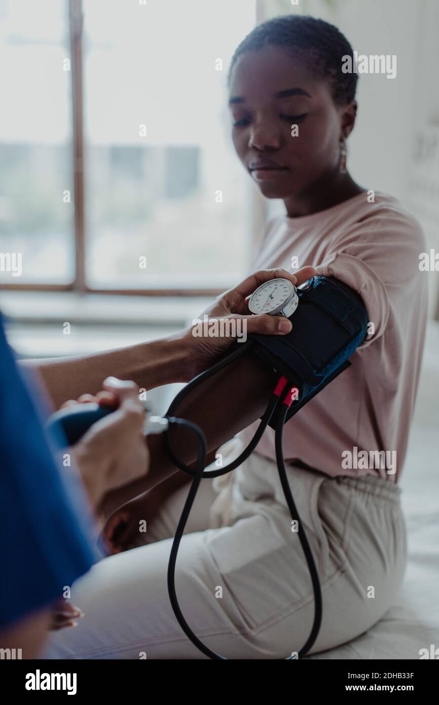 Female nurse checking blood pressure hi-res stock photography and ...