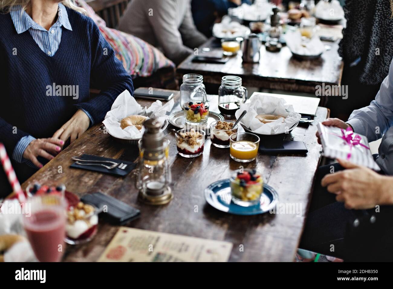 Midsection of couple eating brunch at dining table in restaurant Stock ...