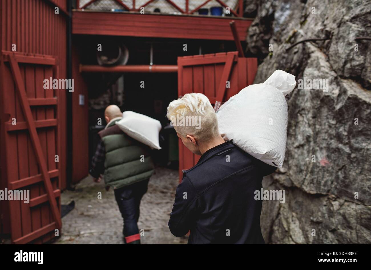 Worker carrying sack hi-res stock photography and images - Alamy
