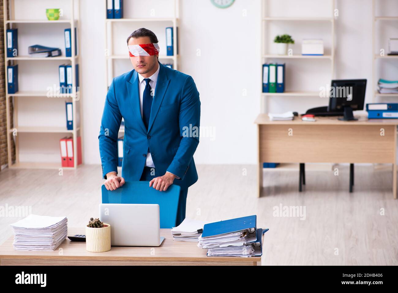 Blindfolded male employee working in the office Stock Photo - Alamy