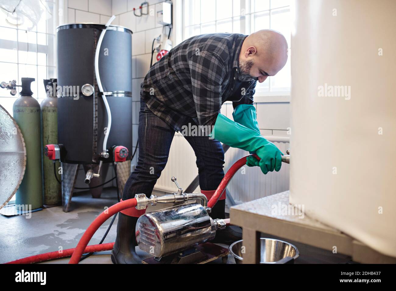 Full length of worker working at brewery Stock Photo - Alamy