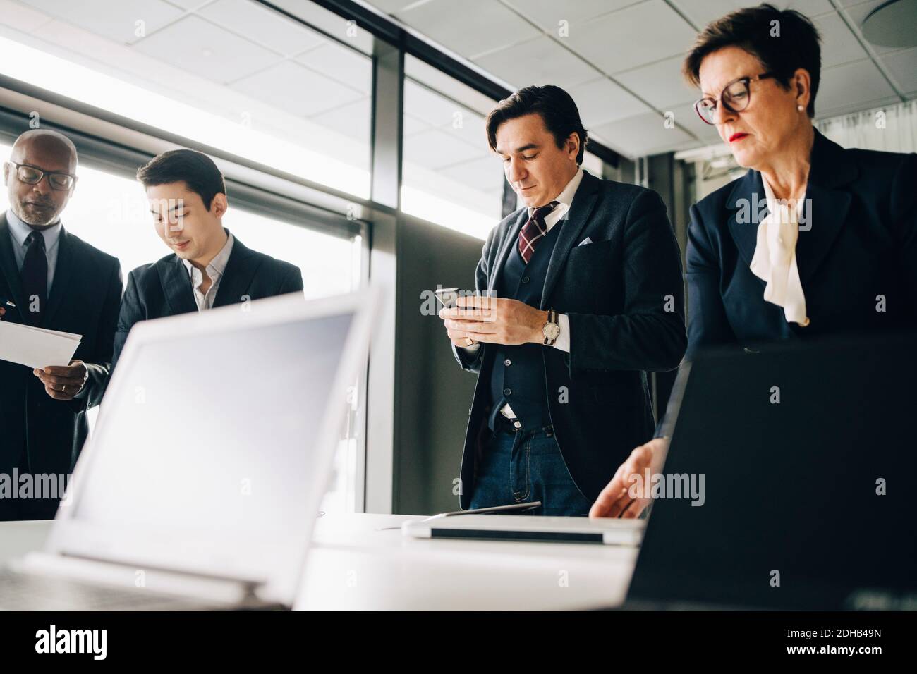 Business people working while standing in board room at office Stock ...