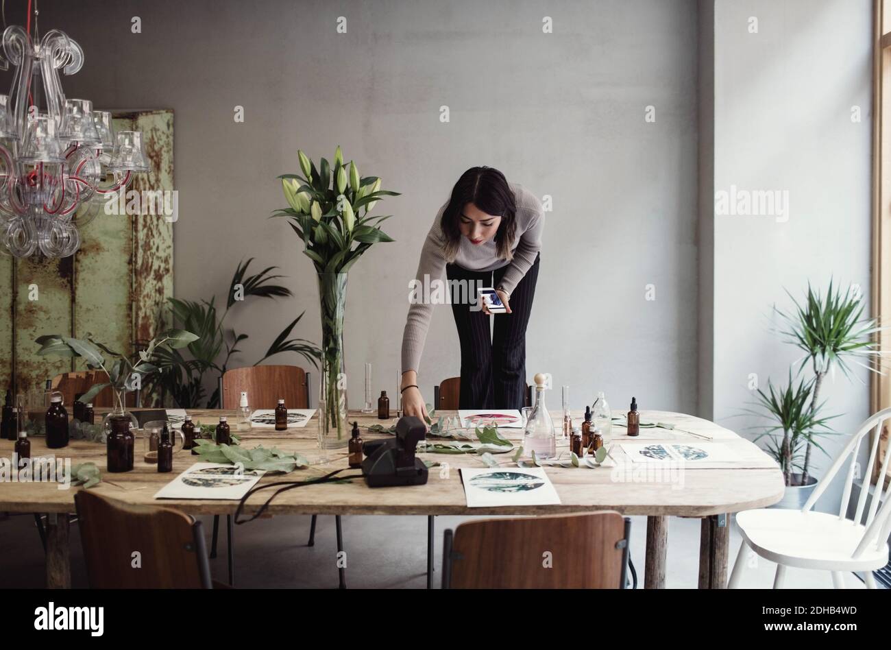 Woman bending over table hi-res stock photography and images - Alamy