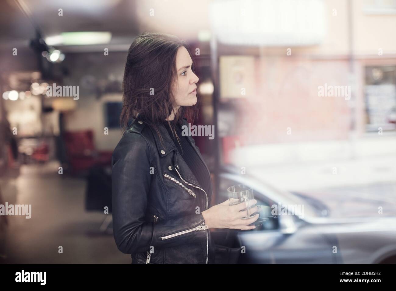 Woman in black leather jacket hi-res stock photography and images - Alamy
