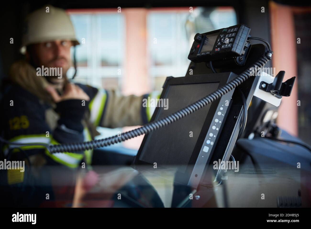 Monitoring equipment against defocused firefighter in fire truck Stock ...