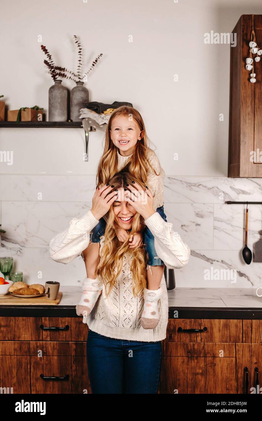 Mother and daughter having fun at christmas time at home Stock Photo ...