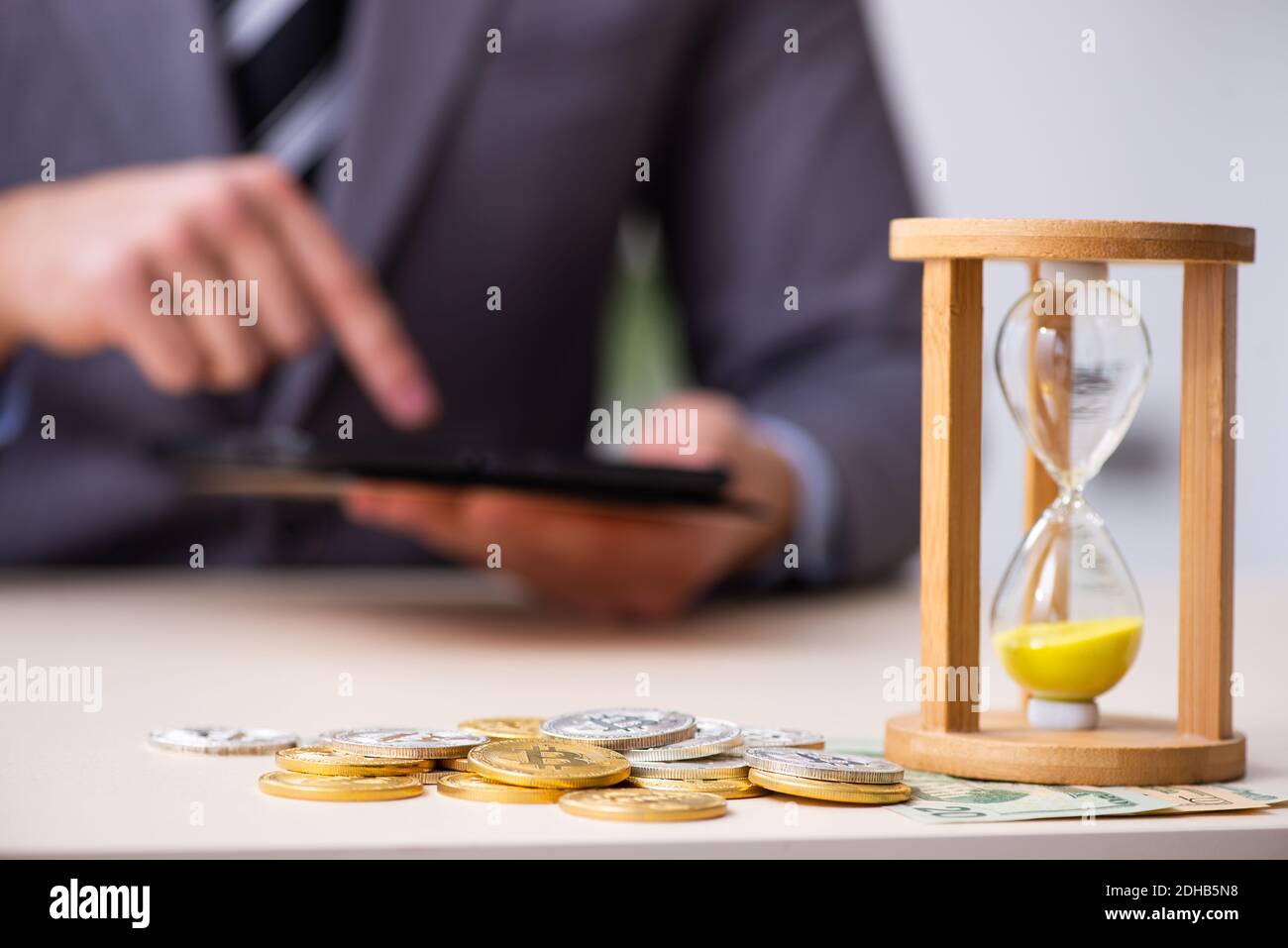 Young man earning money via Internet in time management concept Stock ...