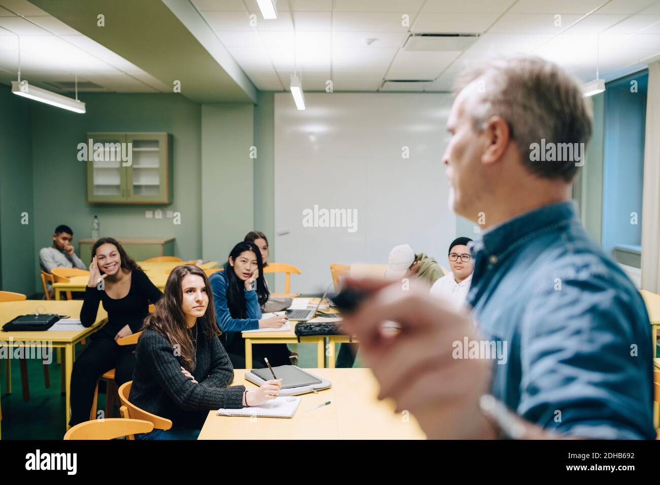 Male teacher teaching high school students in classroom Stock Photo - Alamy