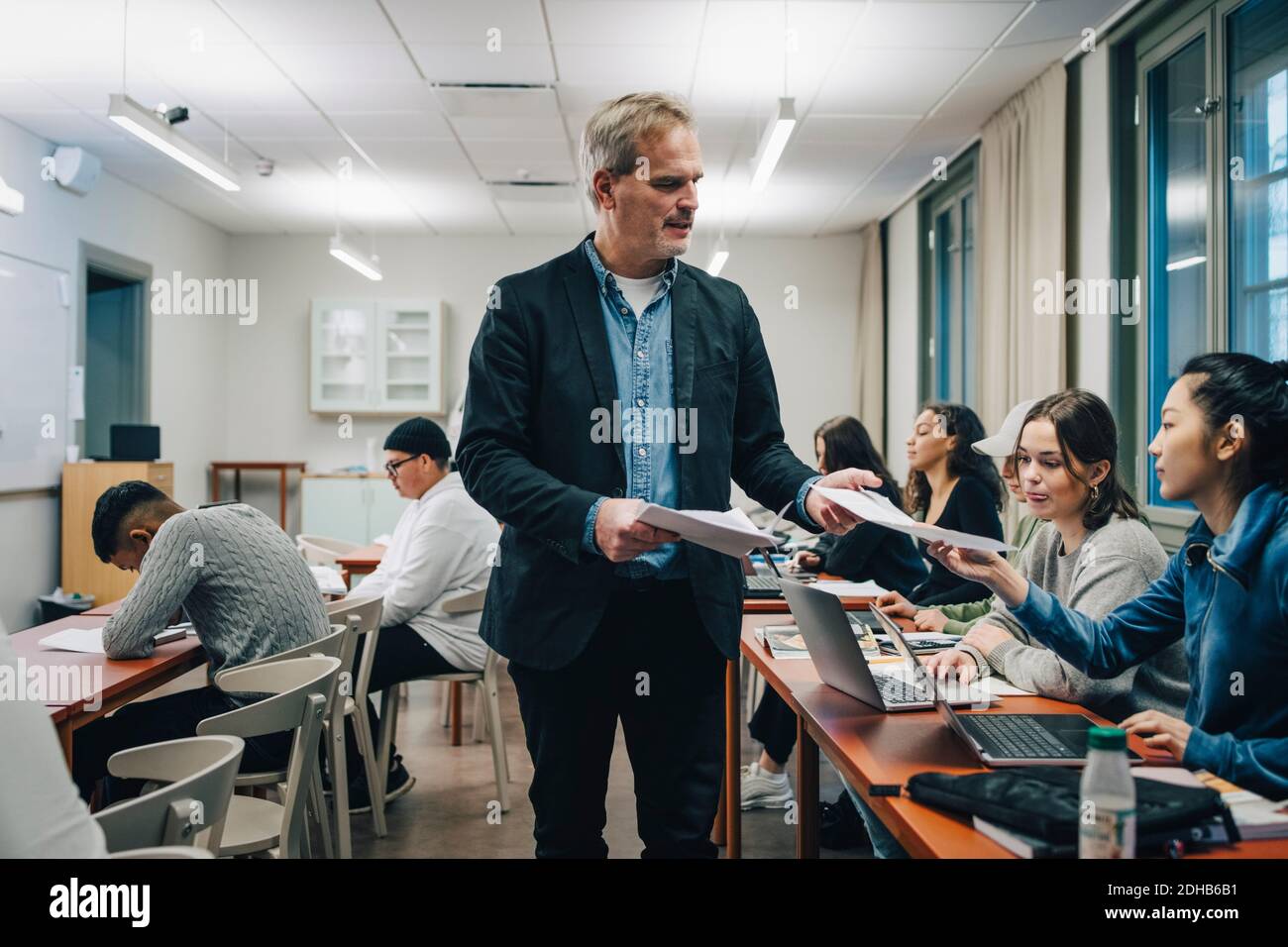 Teacher and student and giving paper hi-res stock photography and ...