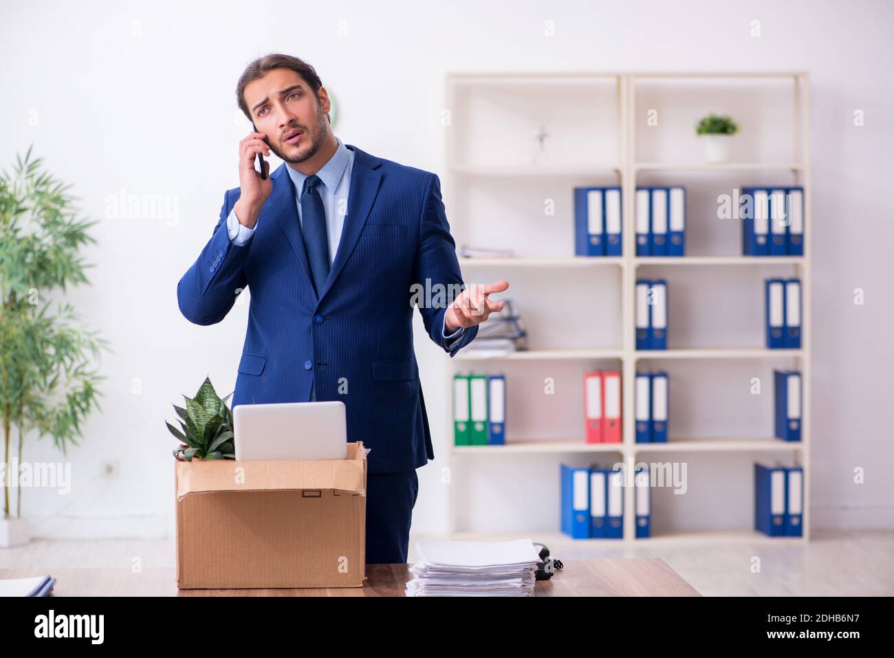 Young man being fired from his work Stock Photo - Alamy