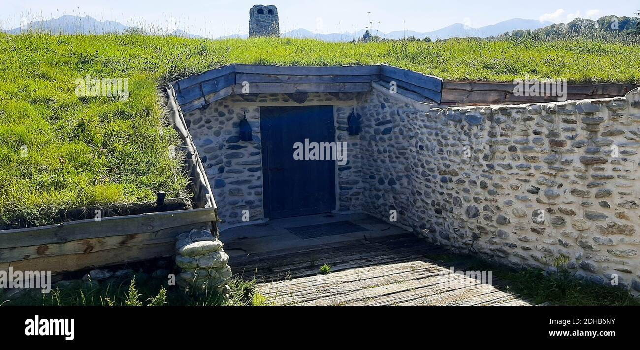 House or bunker built of stone underground with solid wood door and ...
