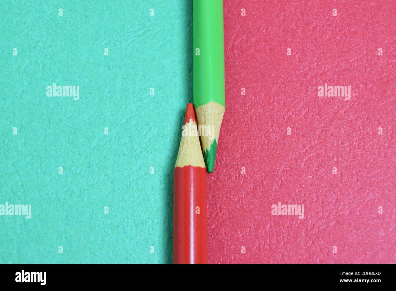 Two colored pencils split a picture in half in two different colors ...
