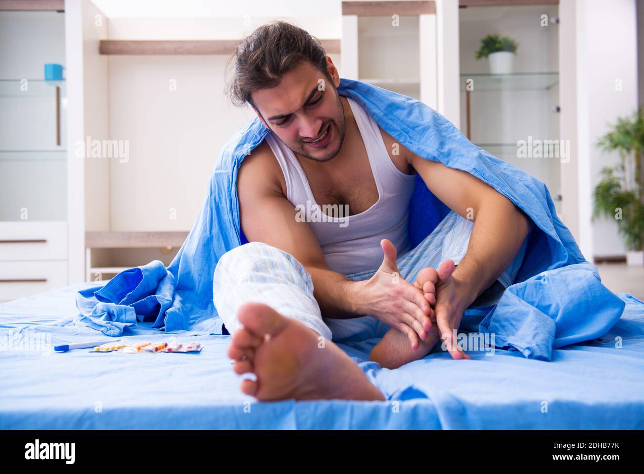 Young sick man suffering at home Stock Photo - Alamy