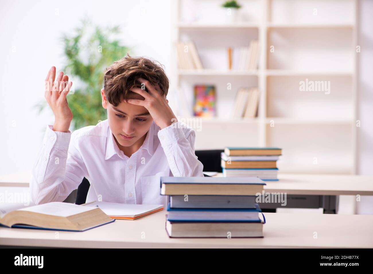 Schoolboy preparing for exams in the classroom Stock Photo - Alamy