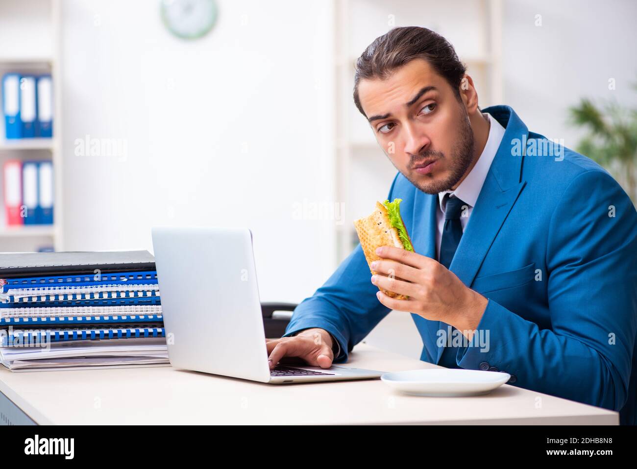 Male employee eating lunch desk hi-res stock photography and images - Alamy