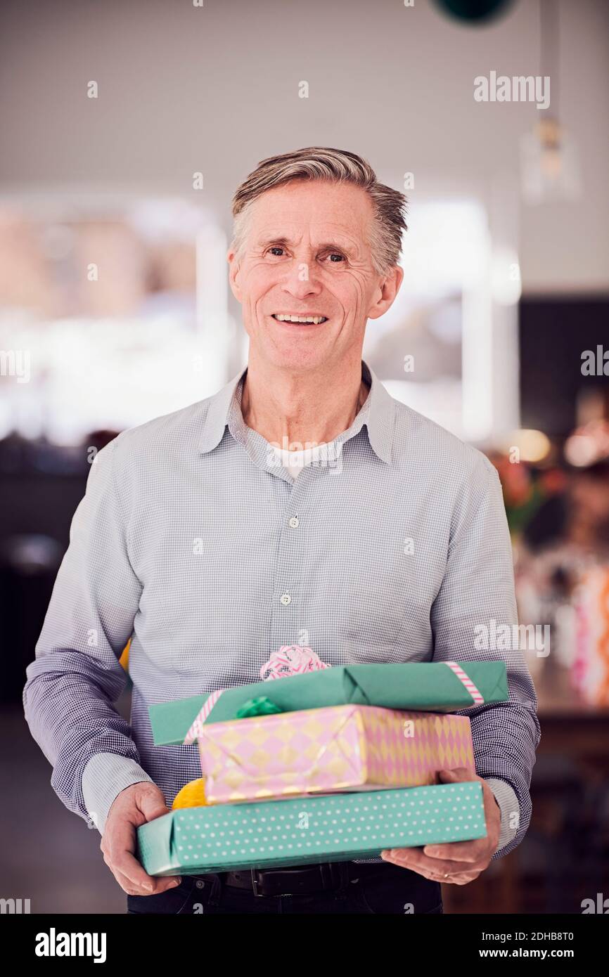 Portrait man holding gift hi-res stock photography and images - Alamy