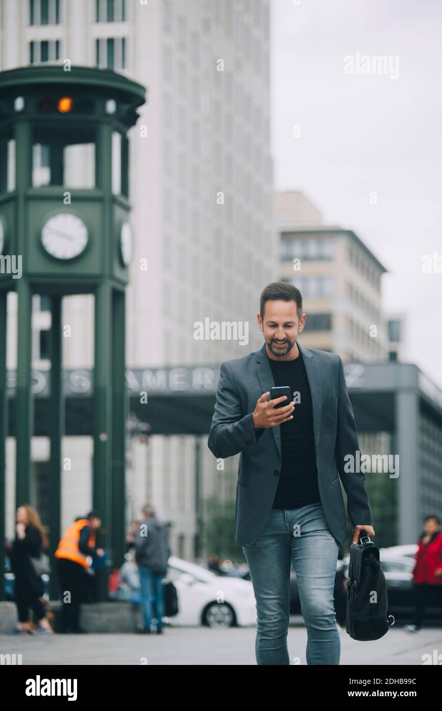 Person using mobile device on street hi-res stock photography and ...