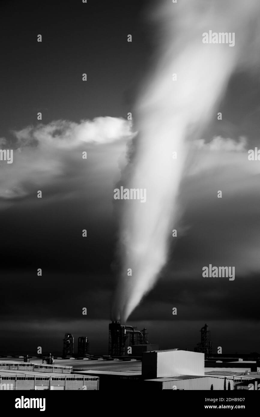 Factory with smoke rising into the sky in Turkey Stock Photo - Alamy