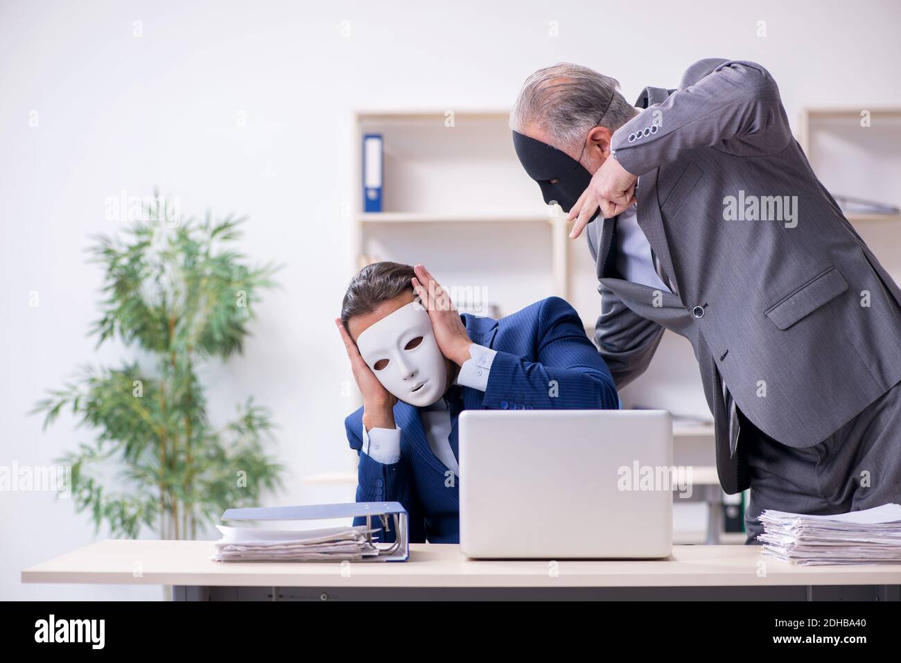 Old boss and young male employee wearing masks Stock Photo - Alamy