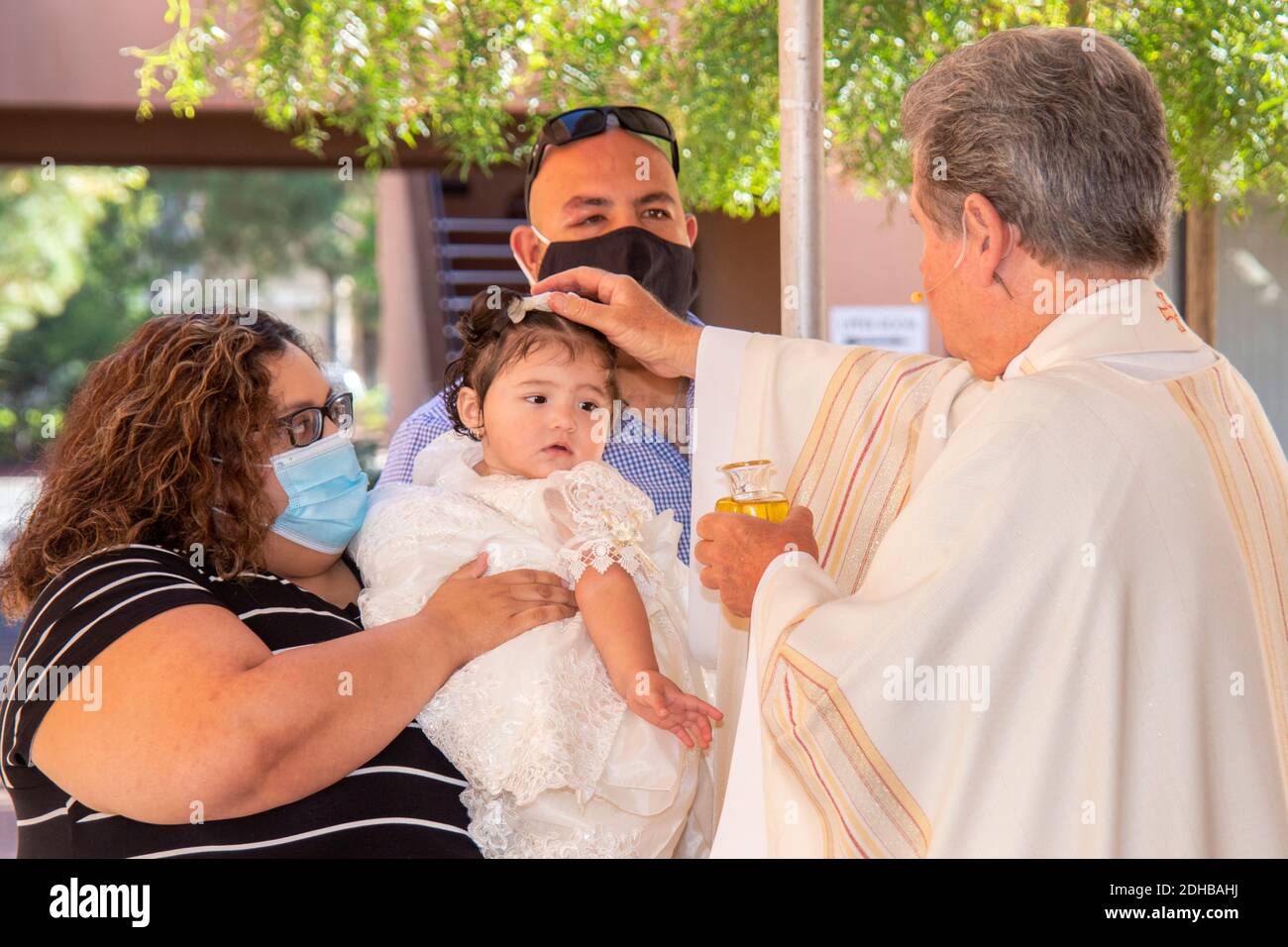 Wearing face masks due to the coronavirus pandemic, a Hispanic family ...