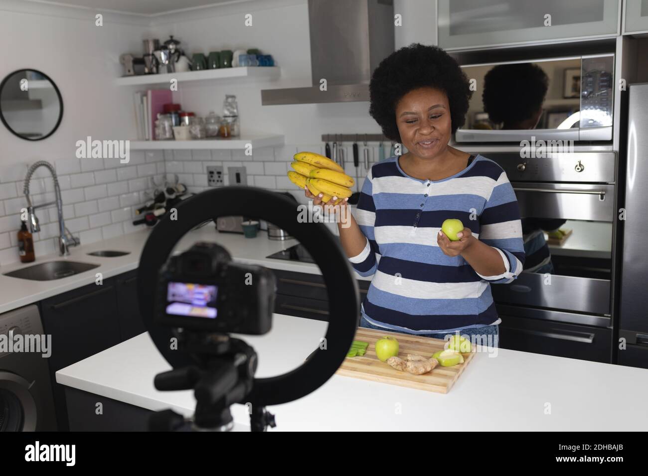 African american female vlogger recording a video in kitchen Stock ...
