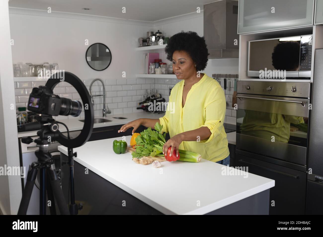 African american female vlogger recording a video in kitchen Stock ...
