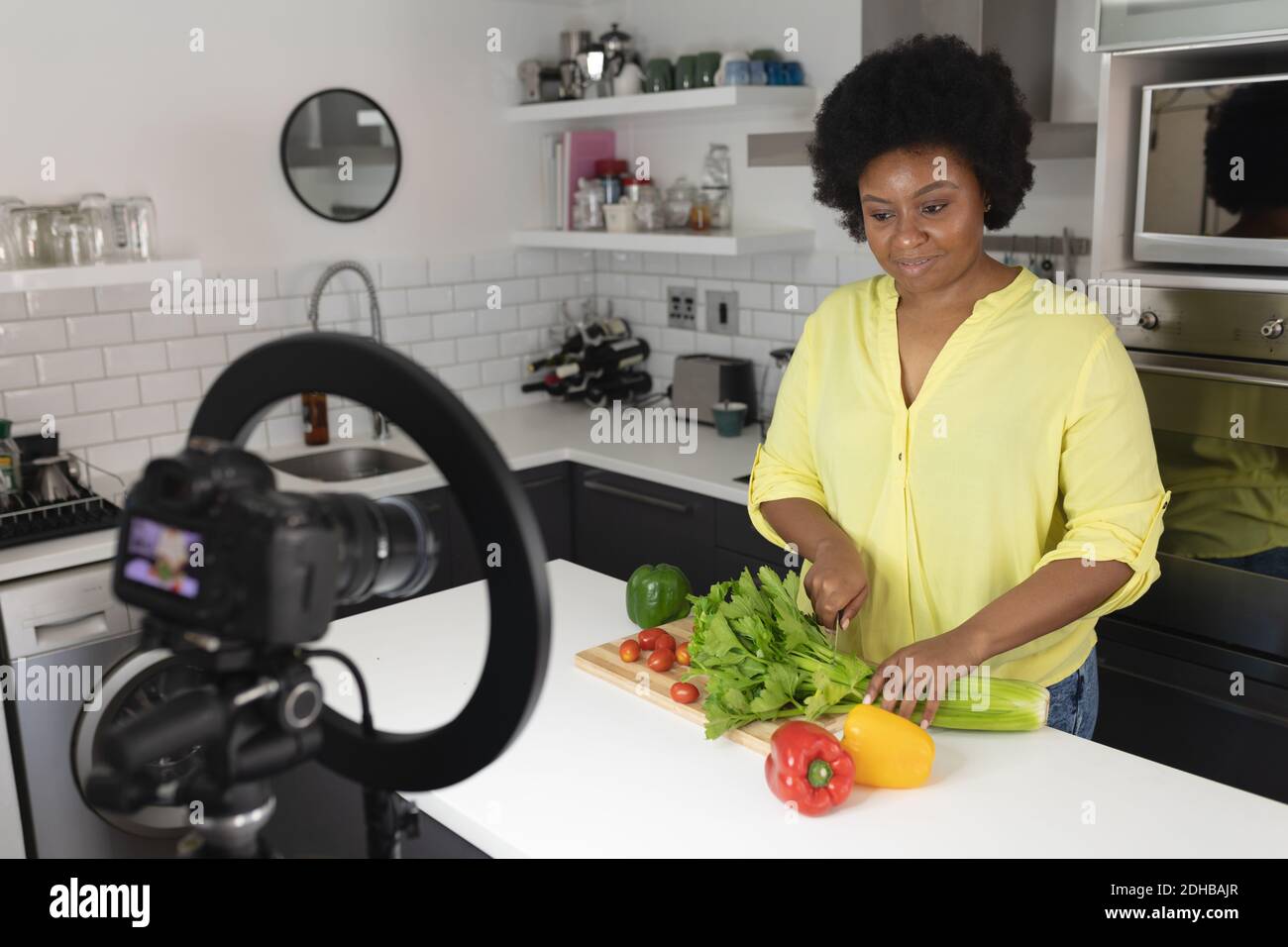 African american female vlogger recording a video in kitchen Stock ...