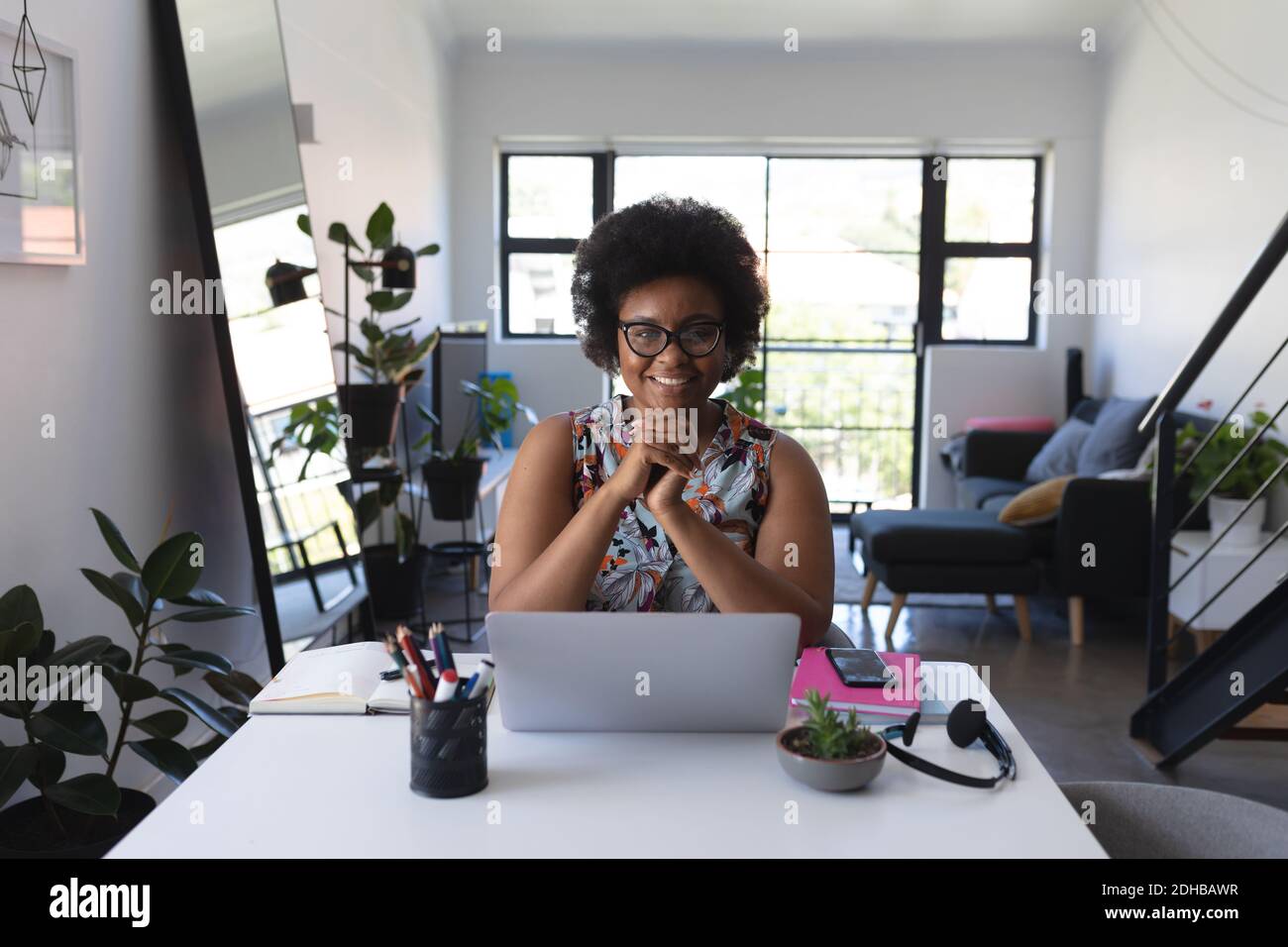 African american woman recording a video blog using laptop. self ...