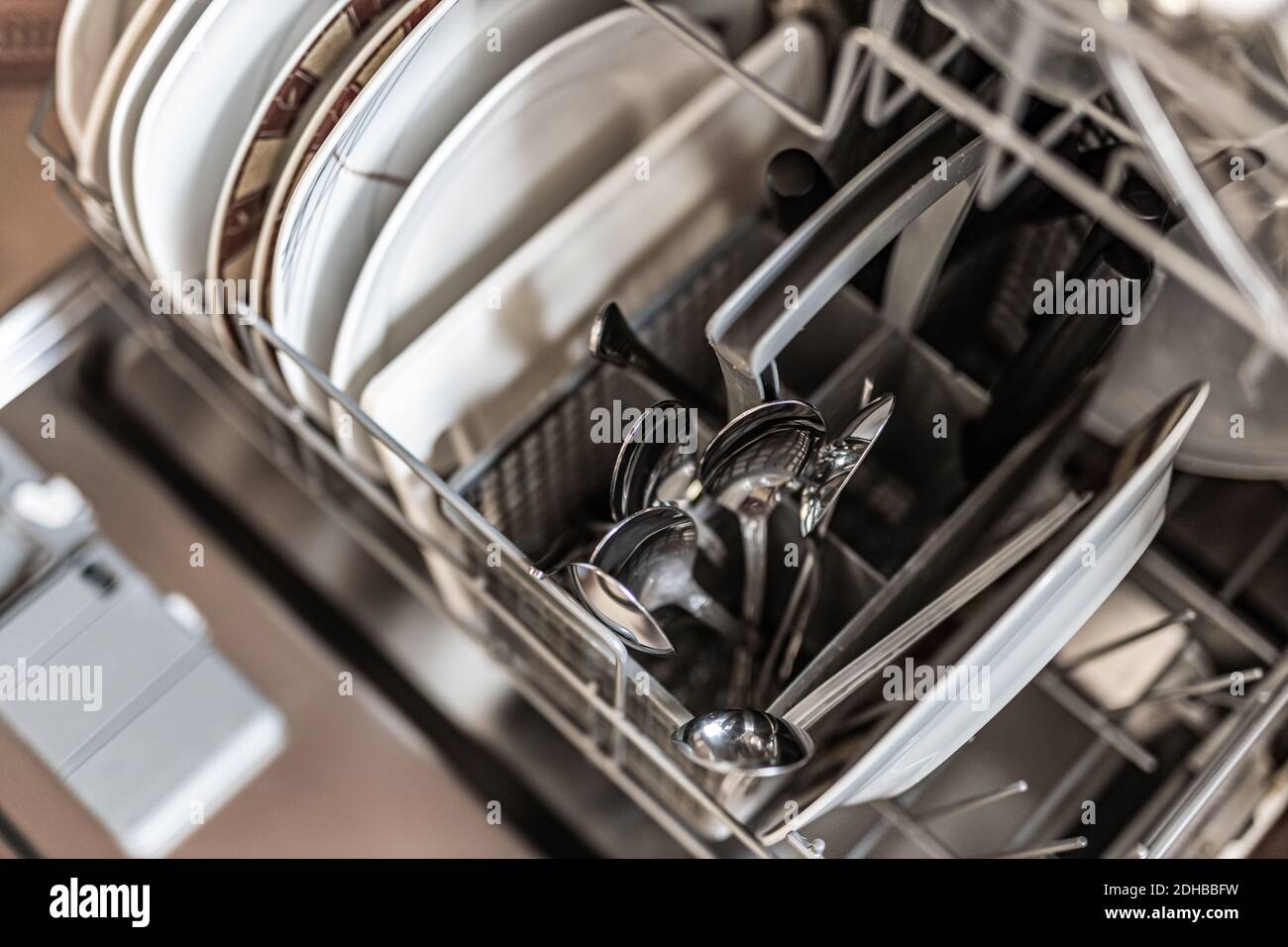 Clean dishware in dishwasher. Close-up view of dishwasher with dishes ...