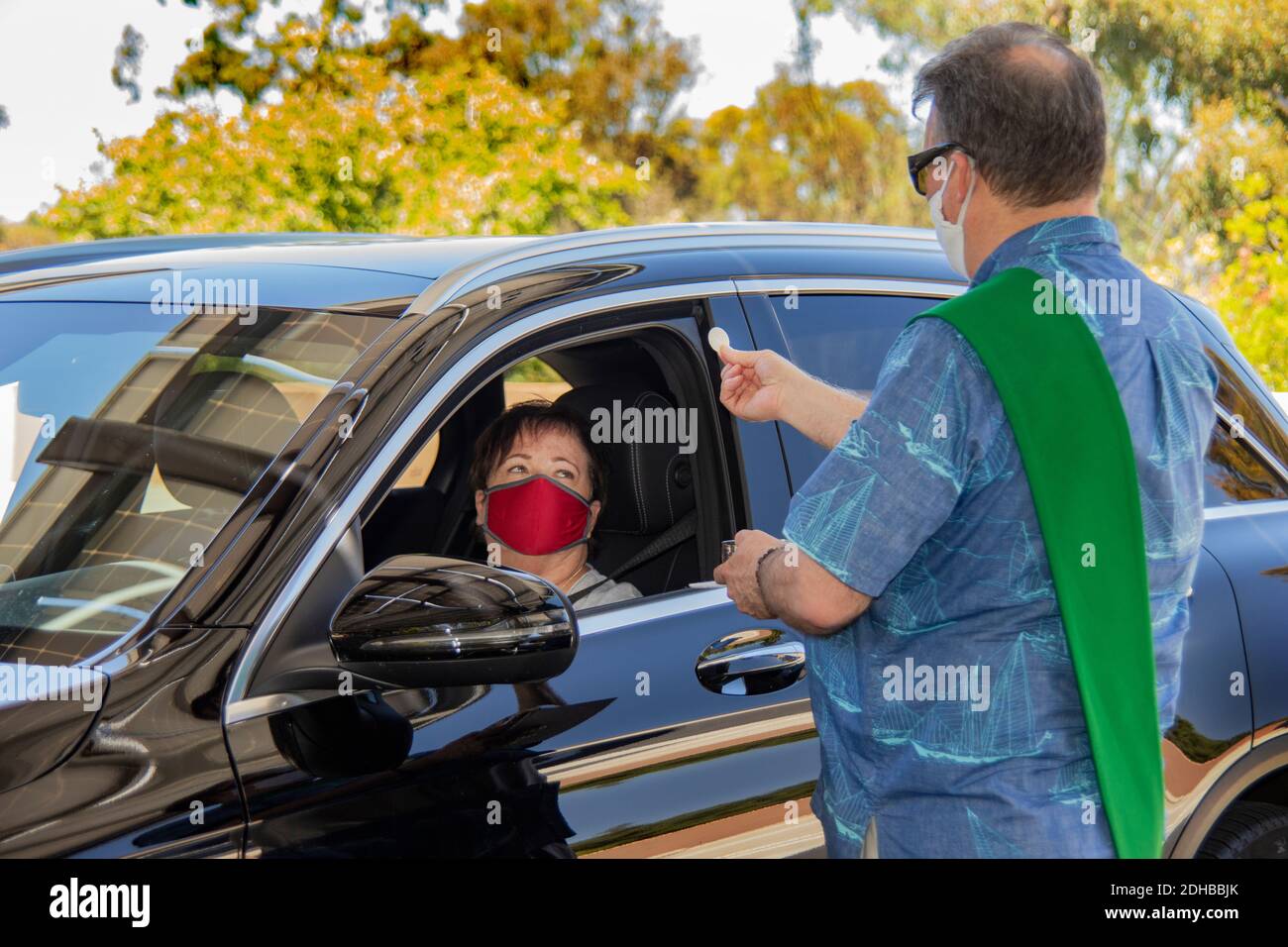 Wearing a ceremonial sash and a face mask due to the coronavirus ...
