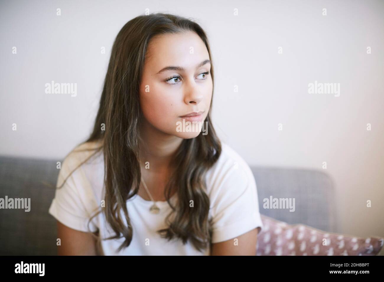 Thoughtful teenage girl sitting at wellness center Stock Photo - Alamy
