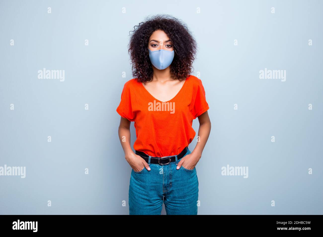 Portrait of pretty wavy-haired youth girl wearing safety textile mask ...