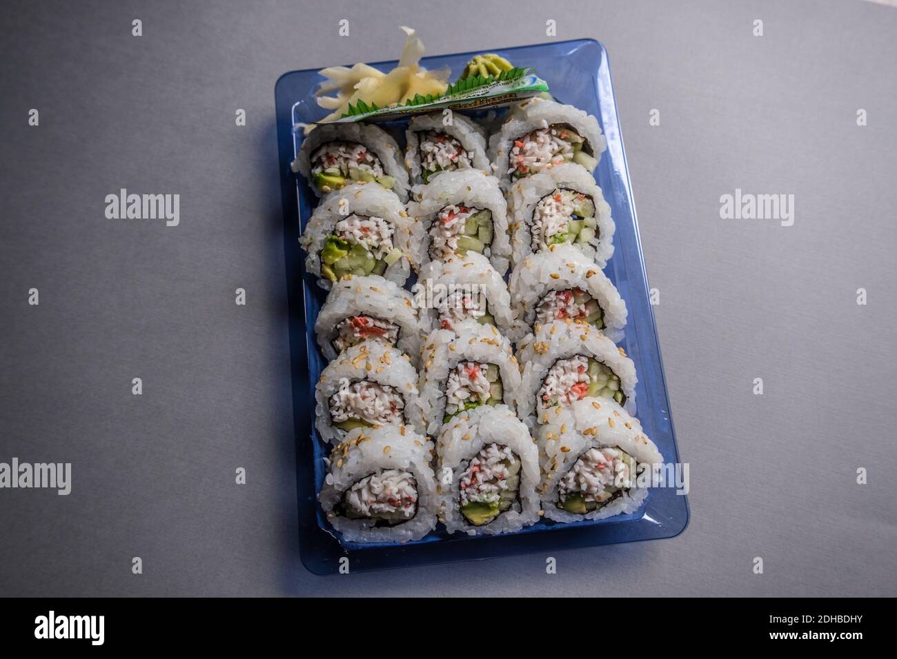 Plastic container of freshly made sushi roll from the grocery store ...