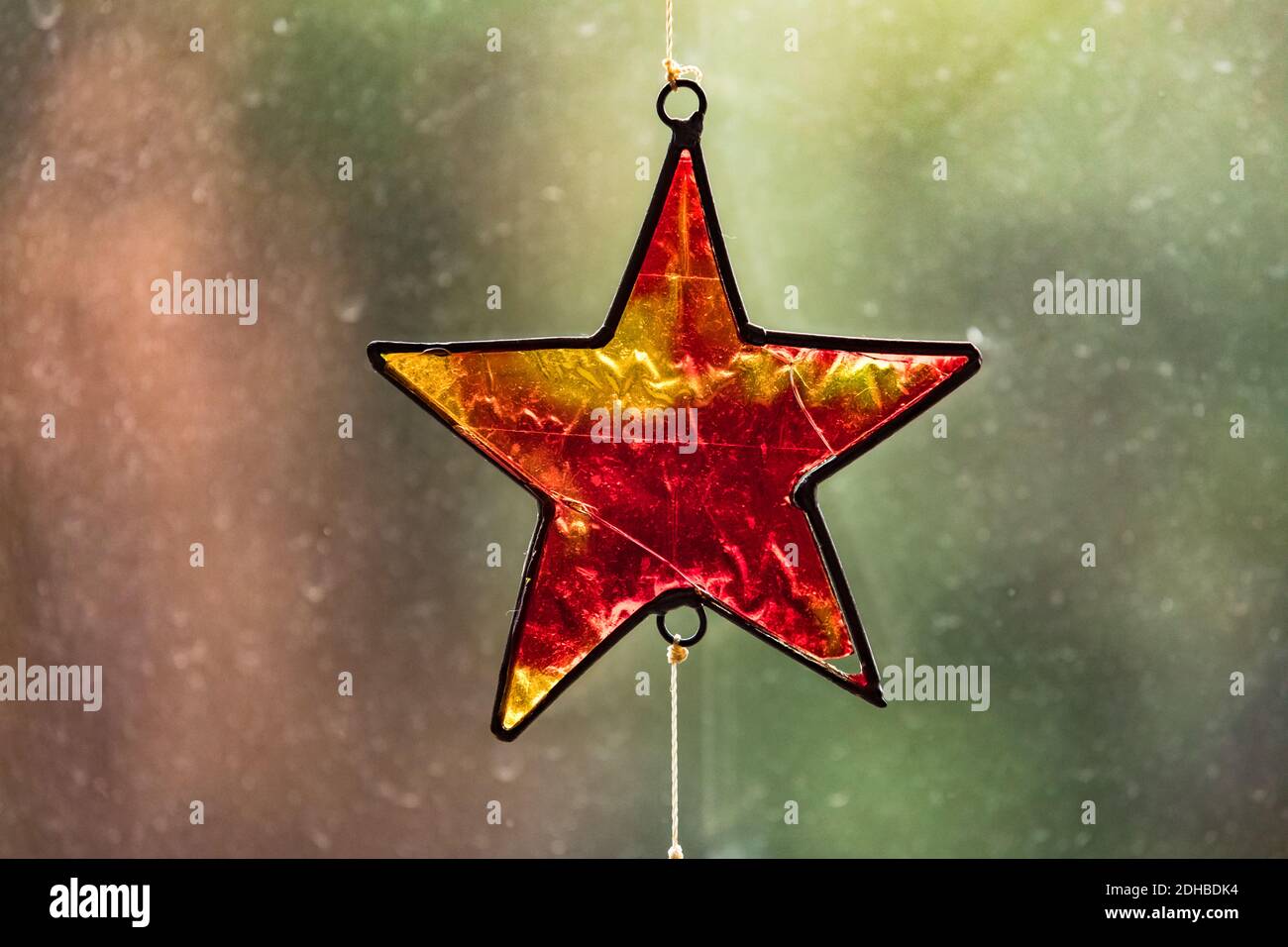 A glass star framed in black metal is a beautiful Christmas ornament in ...