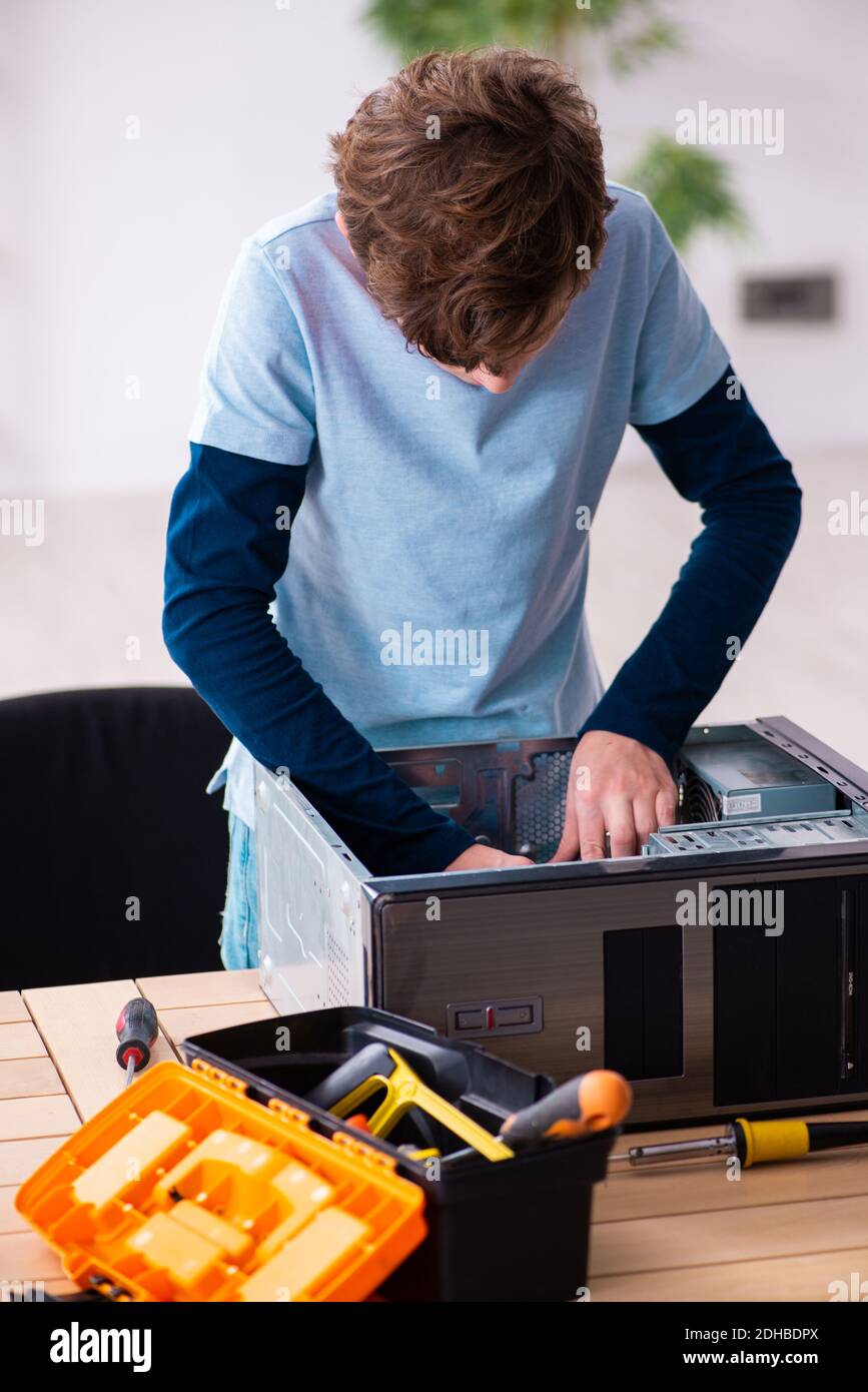 Boy reparing computers at workshop Stock Photo - Alamy