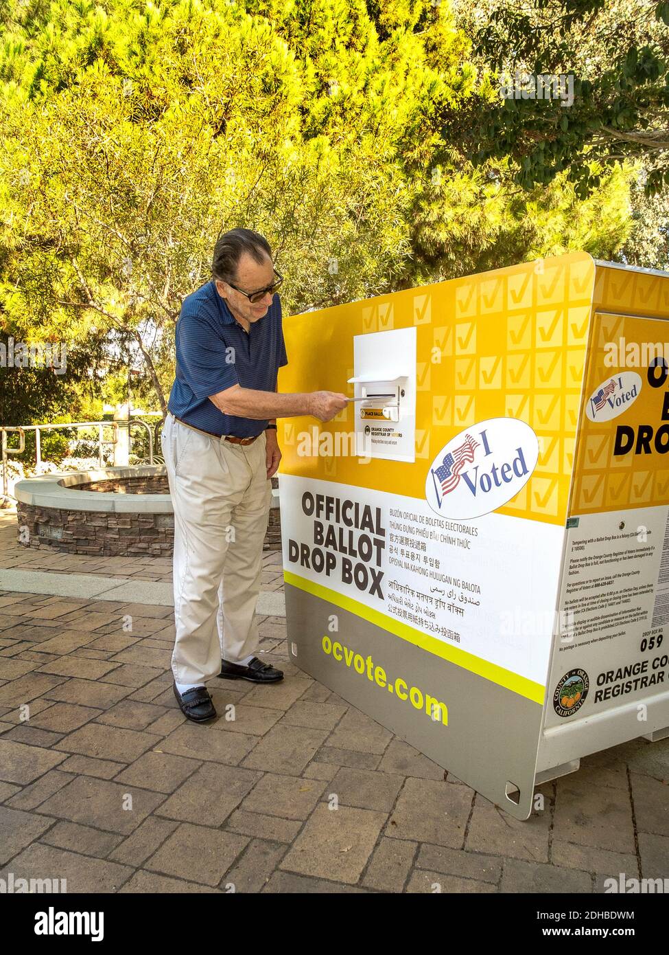 A Senior Man Places His Presidential Election Ballot In An Official