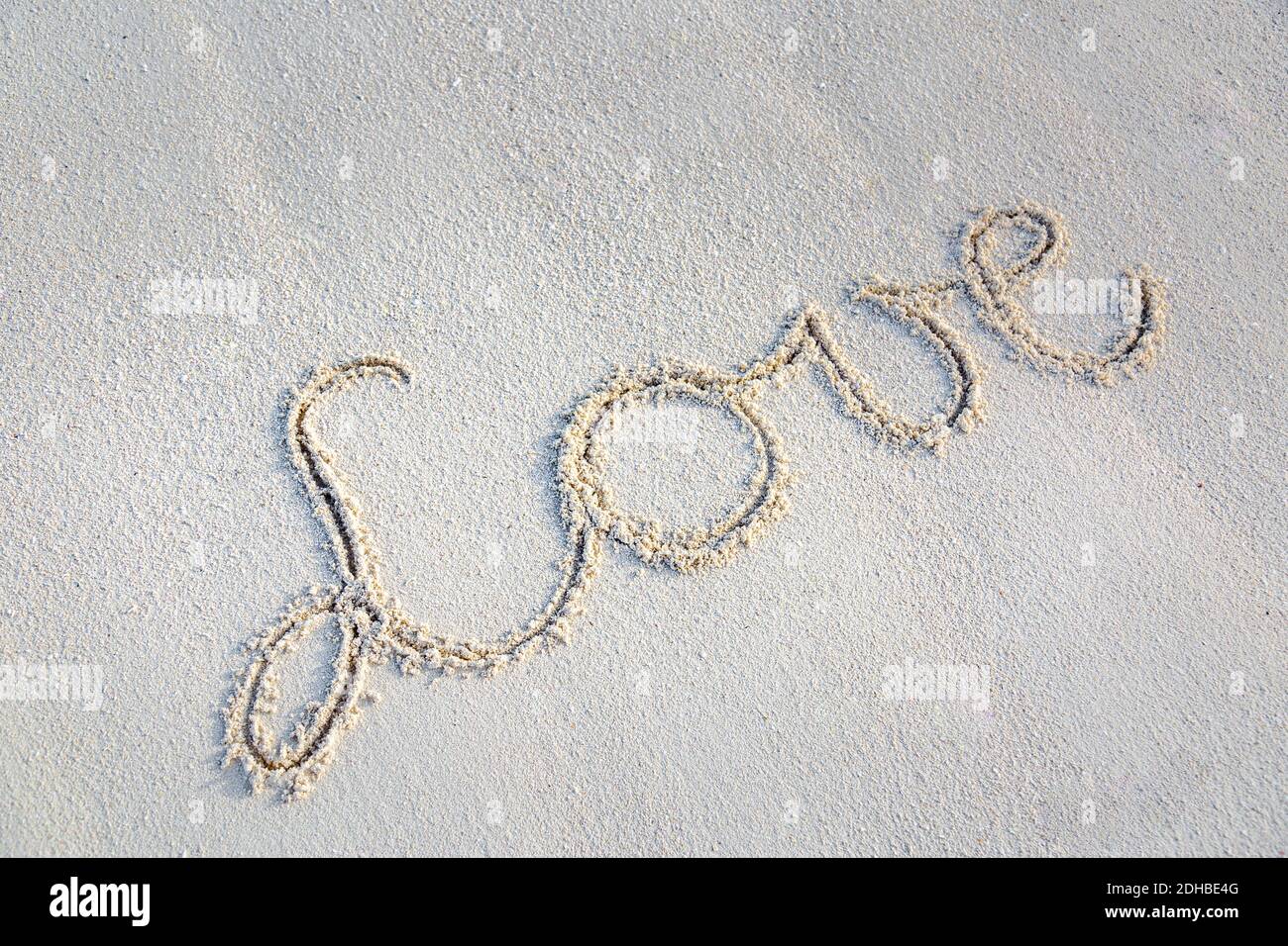 Hand writing love on sand with copy space. Romantic beach pattern, love ...