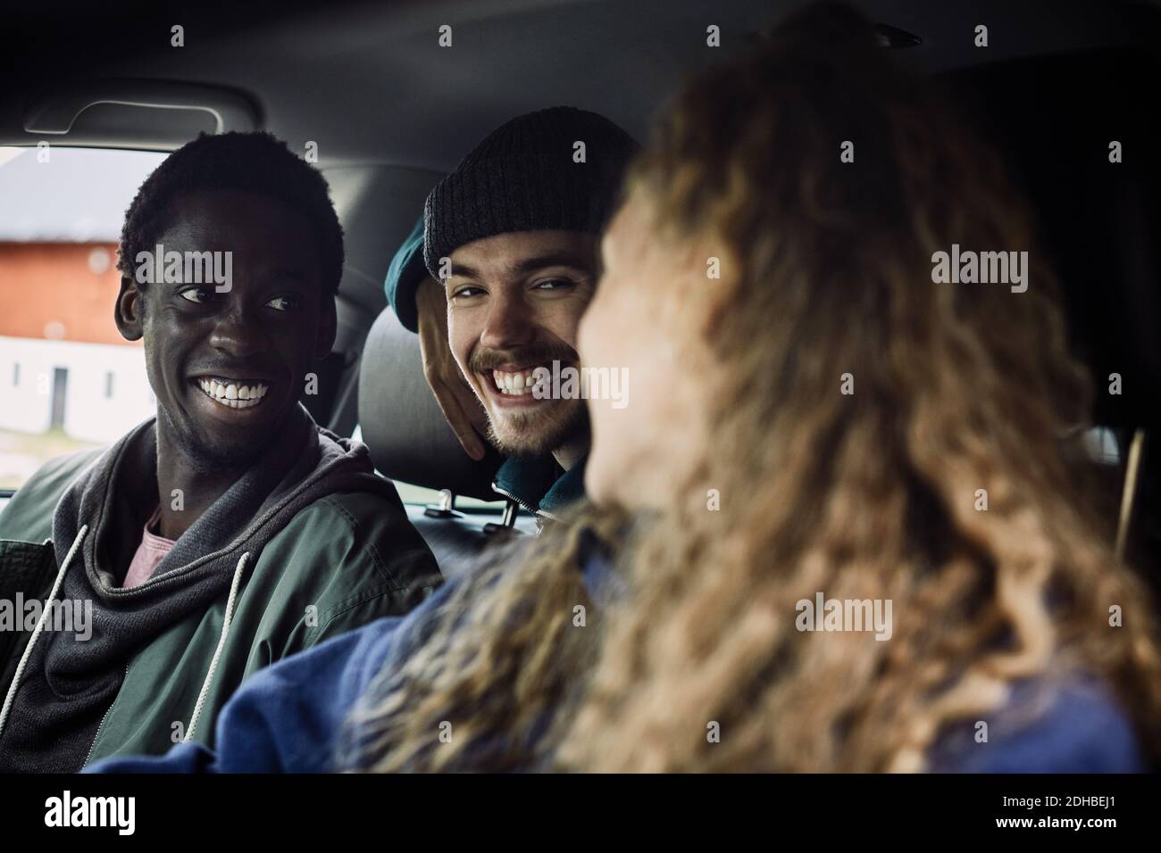 Cheerful friends talking while traveling in car Stock Photo - Alamy