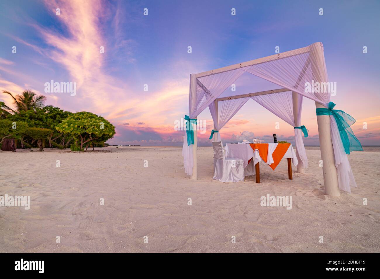 Amazing romantic dinner on the beach on wooden deck with candles under ...
