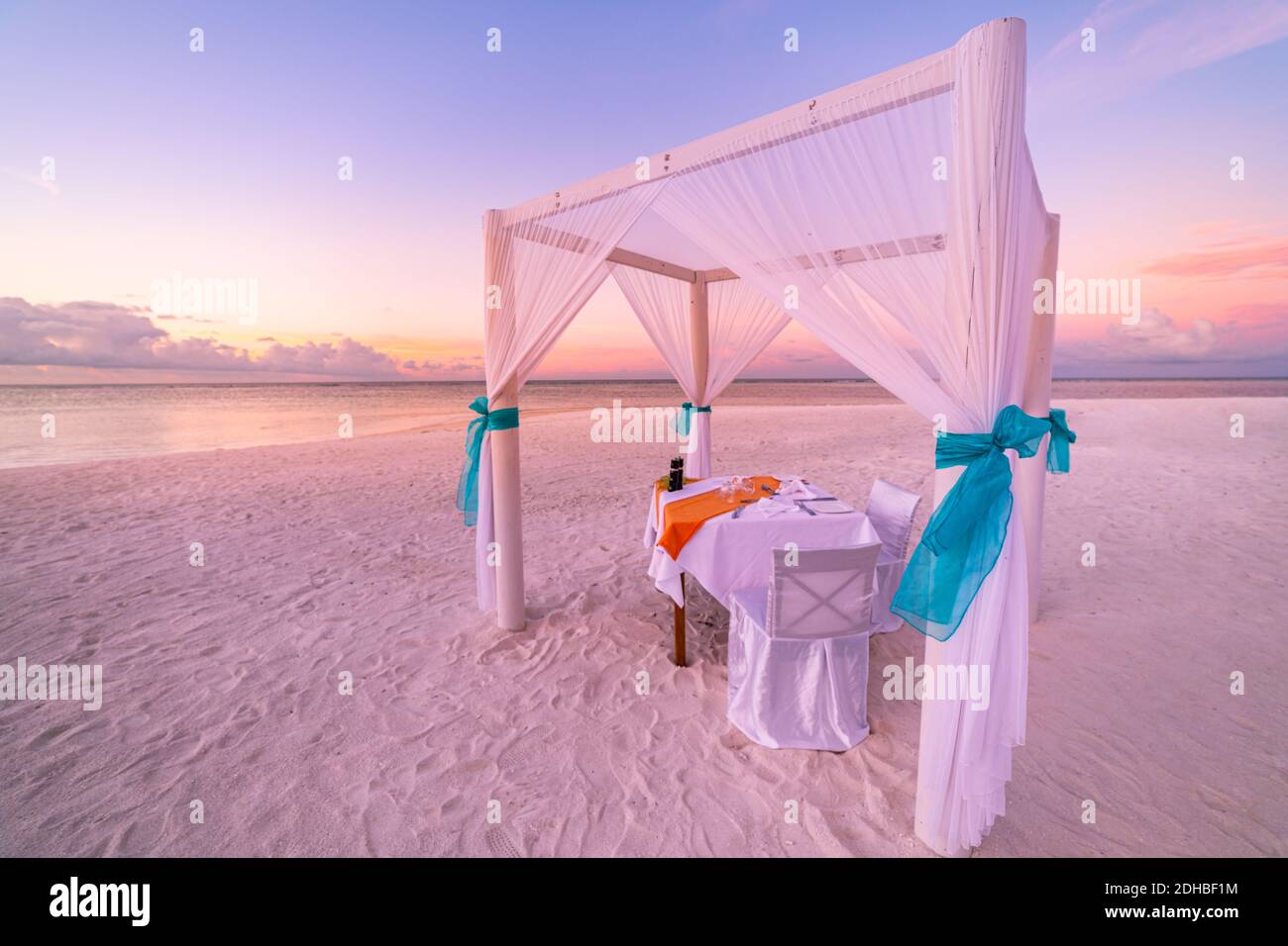 Amazing romantic dinner on the beach on wooden deck with candles under ...