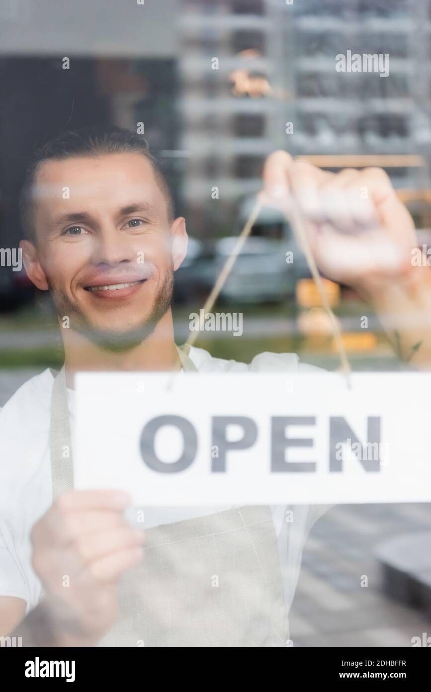 happy barista hanging card with open lettering on cafe entrance door ...