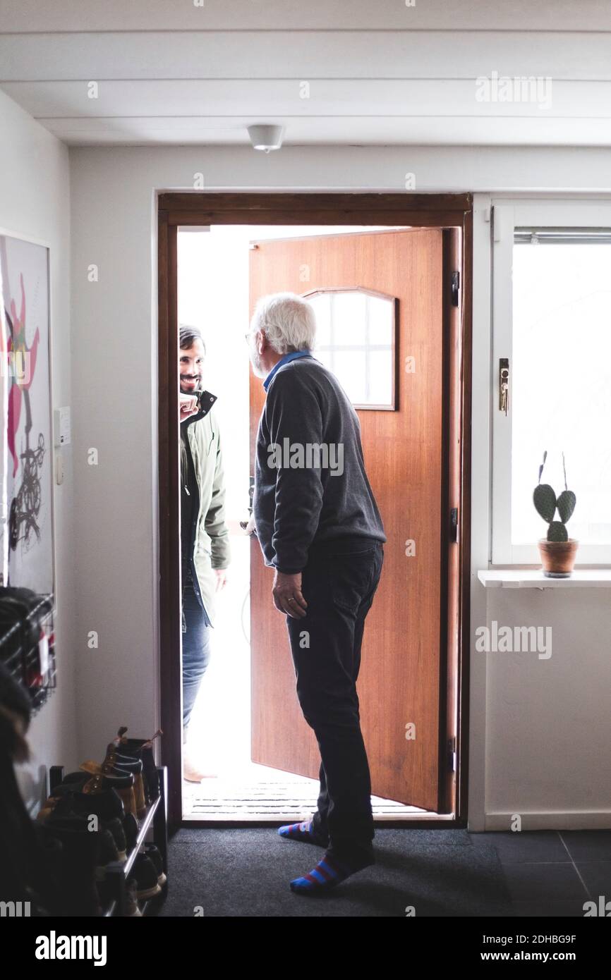 Doctor opening door welcoming patient hi-res stock photography and ...