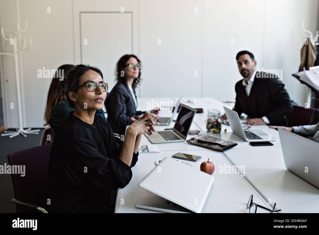 Business people sitting conference table hi-res stock photography and ...
